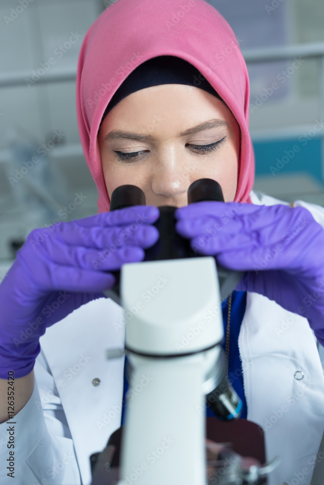 muslim lab worker with hijab or researcher doing an analysis in Stock ...