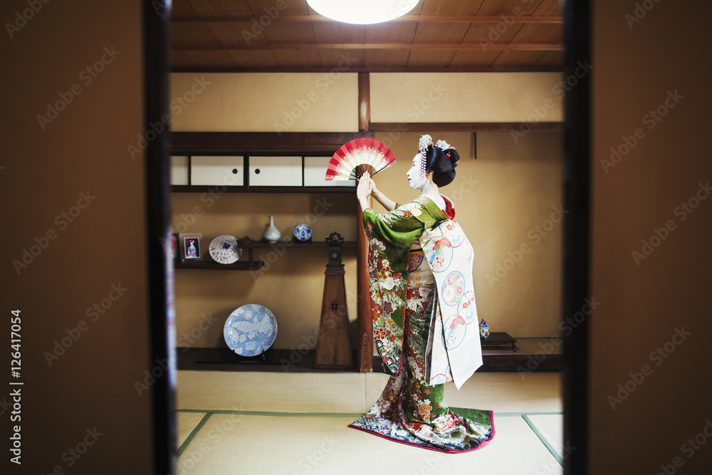 Fotografie A woman dressed in the traditional geisha style, wearing a ...