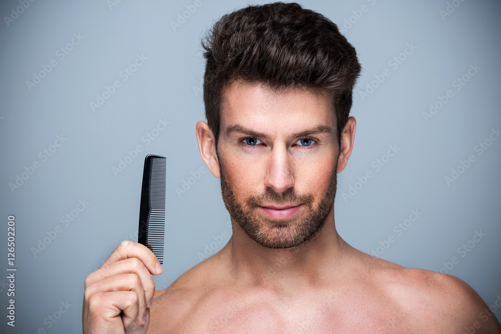 Man combing his hair Stock Photo | Adobe Stock