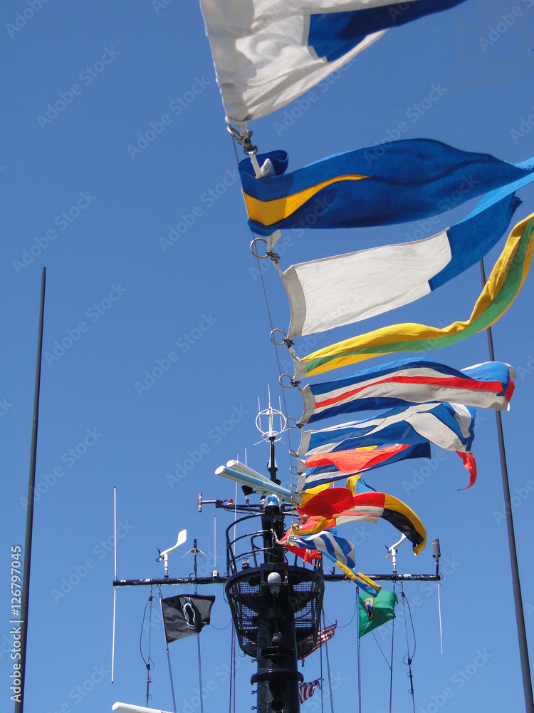 Signal flags flying against blue sky on the Coast Guard cutter USCGC ...