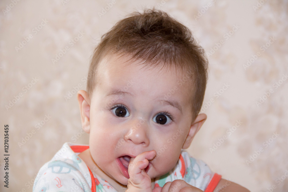 boy was crying and biting your fingers, climb first teeth. grow a baby ...