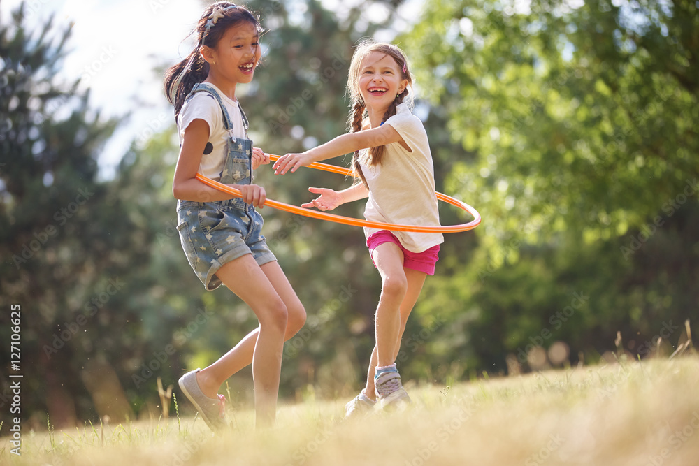 Two girls with hula hoop Stock Photo | Adobe Stock