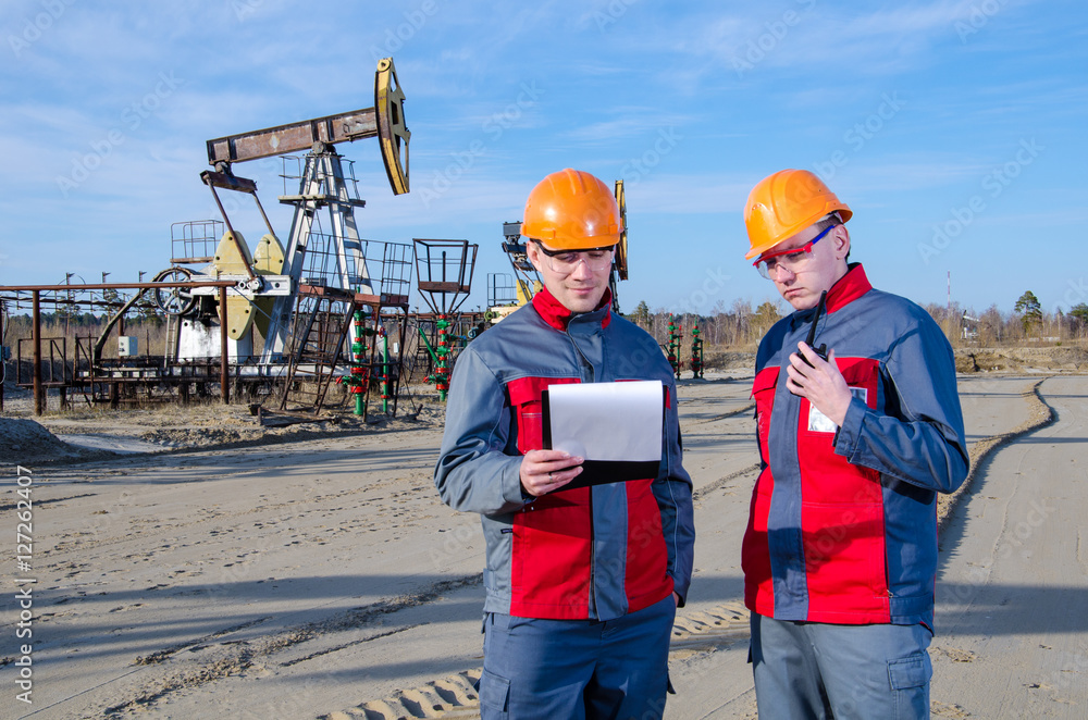 Workers In The Oilfield One Talking On The Radio Pump Jack And