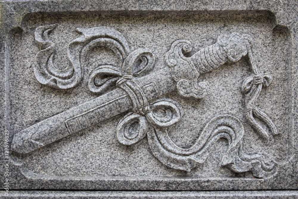 The object carved on the marble is a treasured sword which symbolizes ...