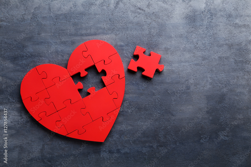 Red puzzle heart on grey wooden background Stock Photo | Adobe Stock