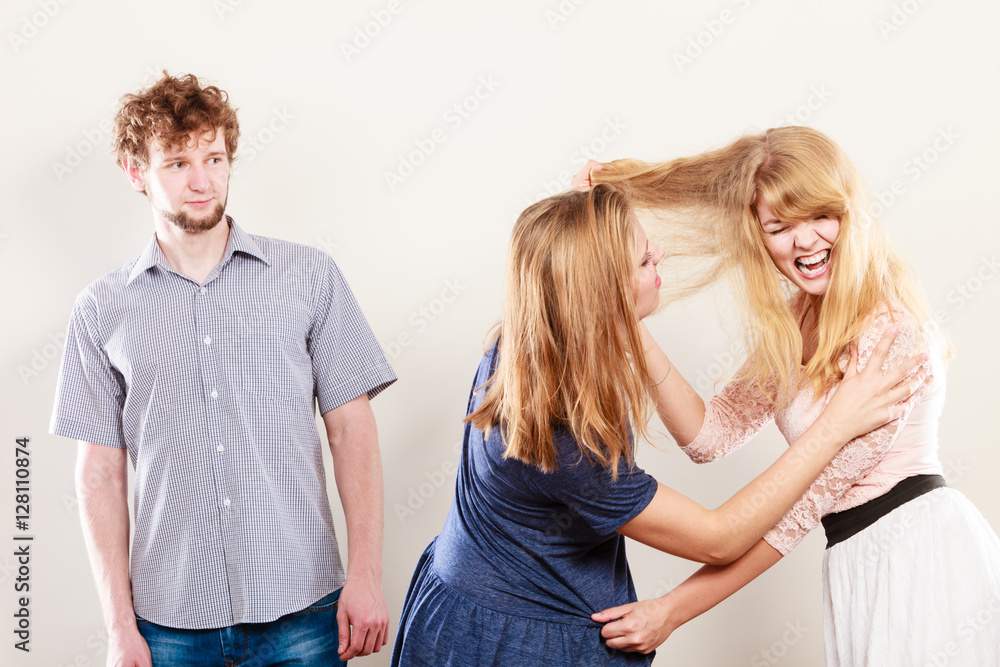 Aggressive mad women fighting over man. Stock Photo | Adobe Stock