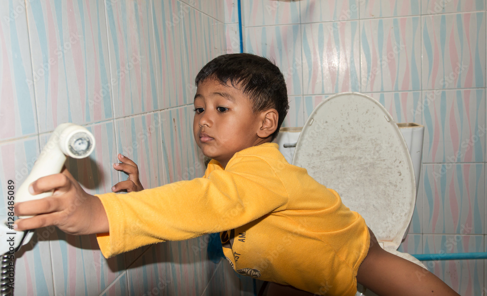 cute child little asian boy defecate in toilet Stock Photo | Adobe Stock