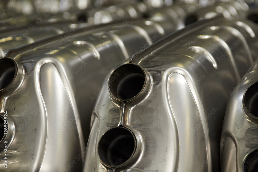 Industrial background. Stacks of new exhausts and silencers mufflers ...