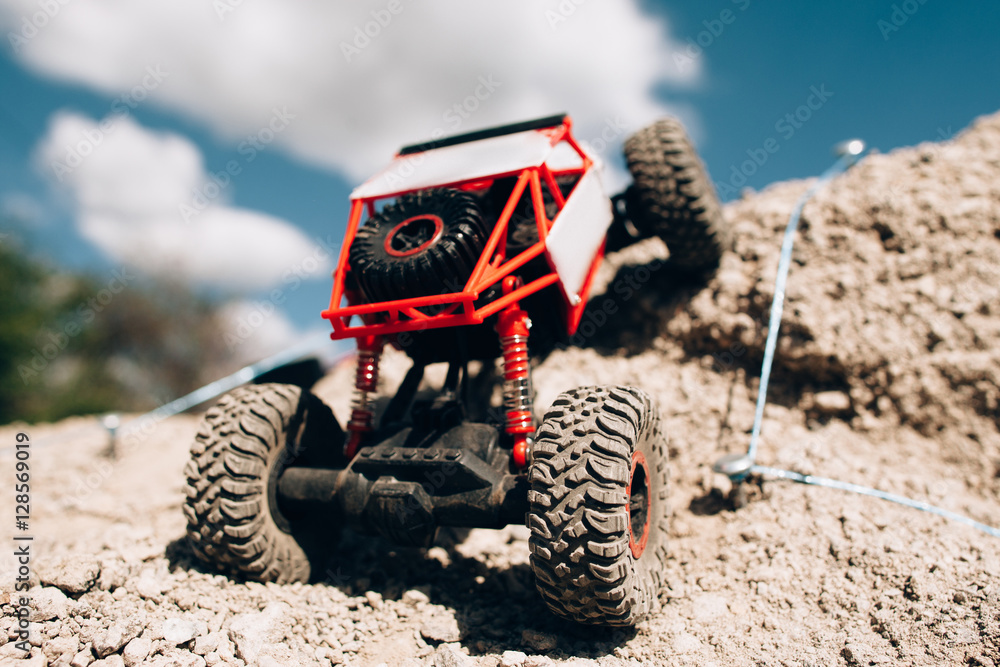 Rc car overcoming rock hill close-up. Crawler rising on rough surface ...