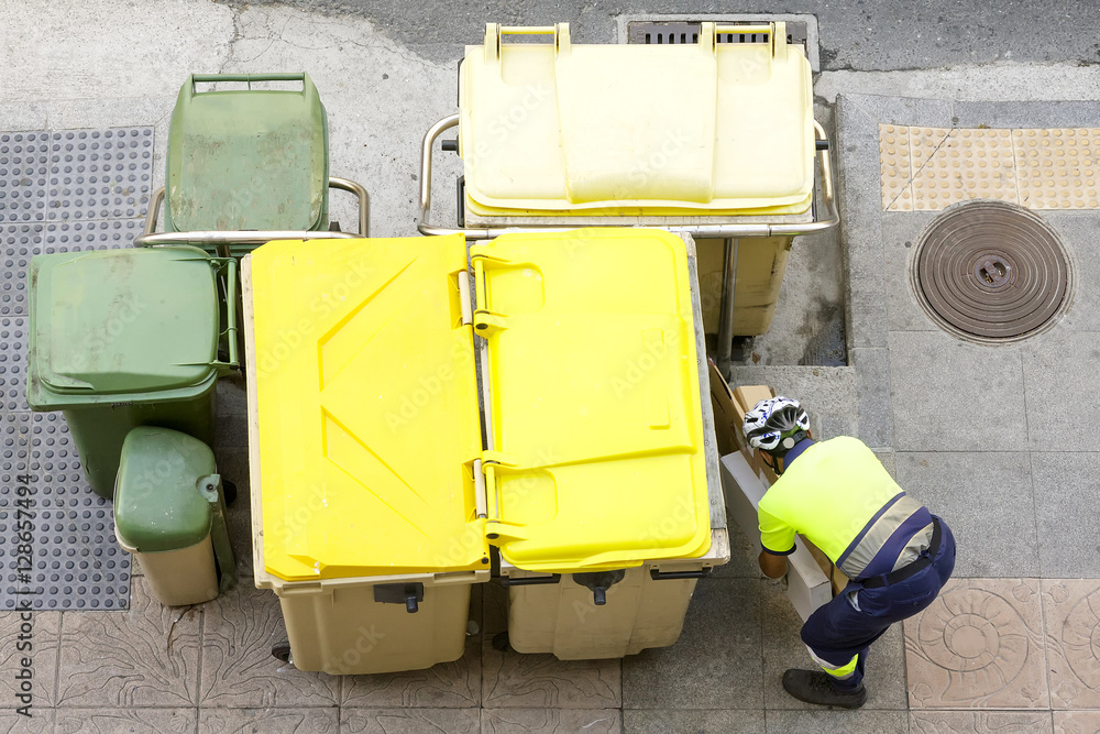 utility worker collecting cardboard in recycle bin garbages containers ...