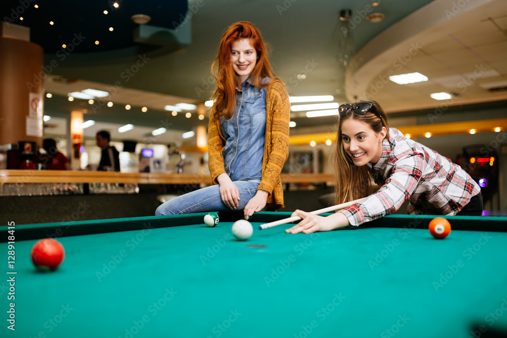 Two female friends playing snooker Stock Photo | Adobe Stock