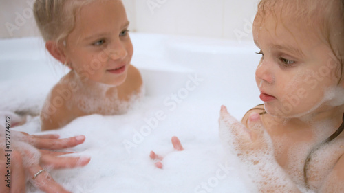 Two cute little sisters bathing in the bath Stock Photo | Adobe Stock Two cute little sisters bathing in the bath Stock Photo | Adobe Stock