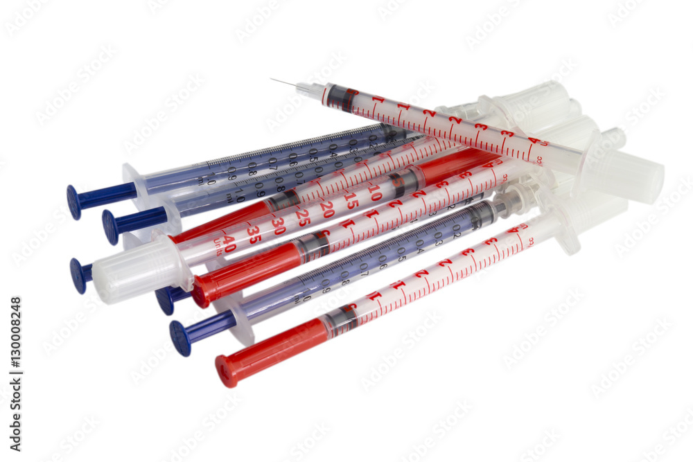 Insulin 40 units syringes. Several red and blue insulin pens lying. one ...