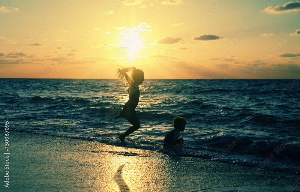 kids playing on the beach at sunset Stock Photo | Adobe Stock