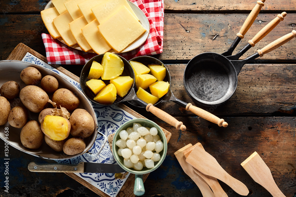 Preparing a traditional Swiss meal of raclette Stock Photo | Adobe Stock