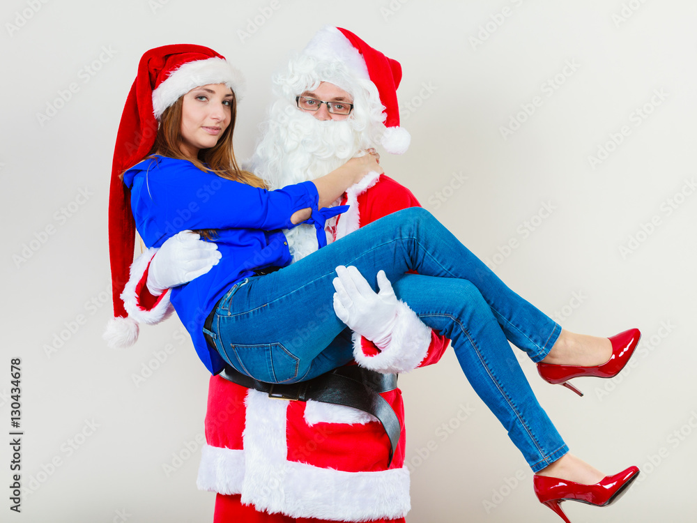 Attractive lady with Santa Claus. Stock Photo | Adobe Stock