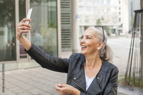 Smiling Mature Woman Taking Selfie With Smartphone Buy This Stock