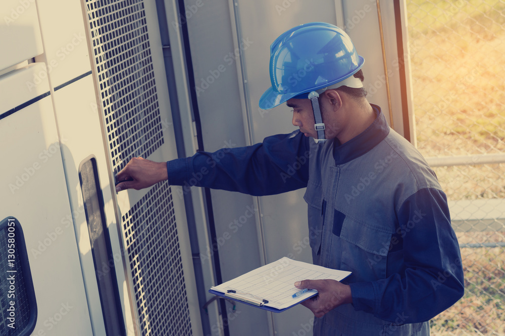 engineer or electrician working on checking and maintenance equipment ...