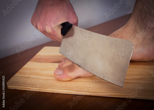 Photo Stock The man with a knife cutting the toes | Adobe Stock