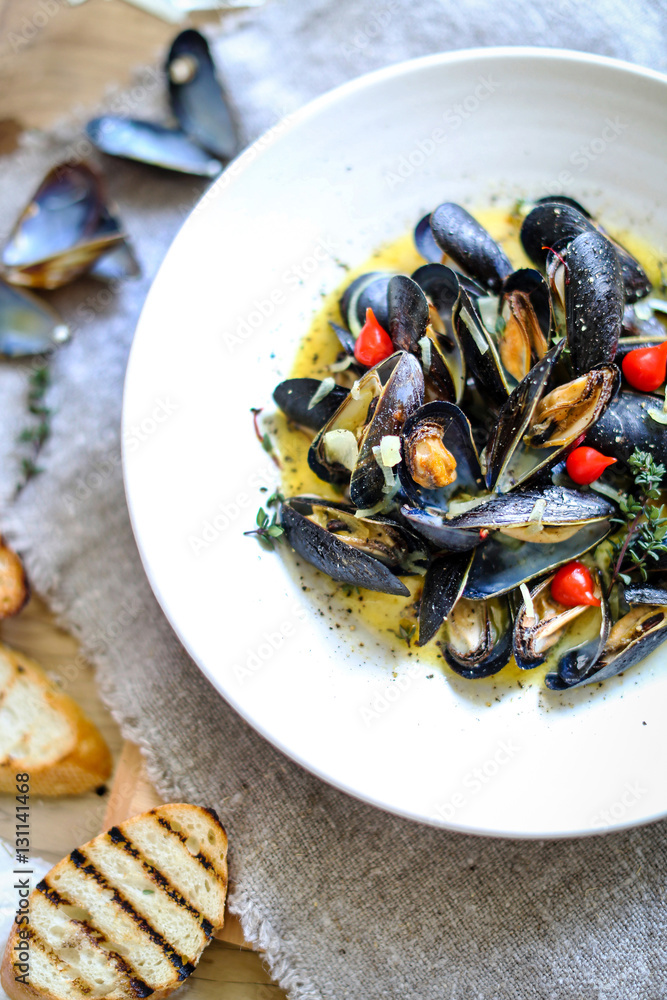 Steamed mussels with butter, bread and saffron Stock Photo | Adobe Stock