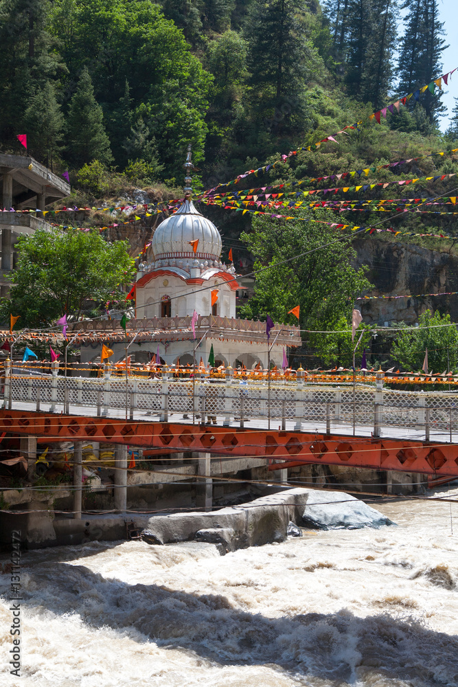 View of the rapid river Parvati near Sightcam a temple and a Gurudwara, Manikaran, Himachal ...