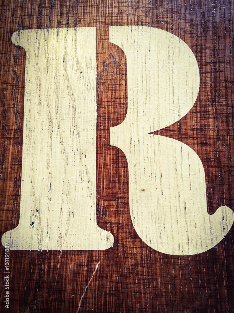 Wooden alphabet letter R, mirrored back. Written letter with paint on a ...