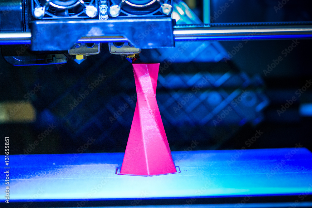 3D printer printing isolated volume triangular object red color on the ...