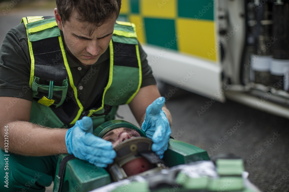 Paramedic fixing head of car crash victim on stretcher Stock Photo ...