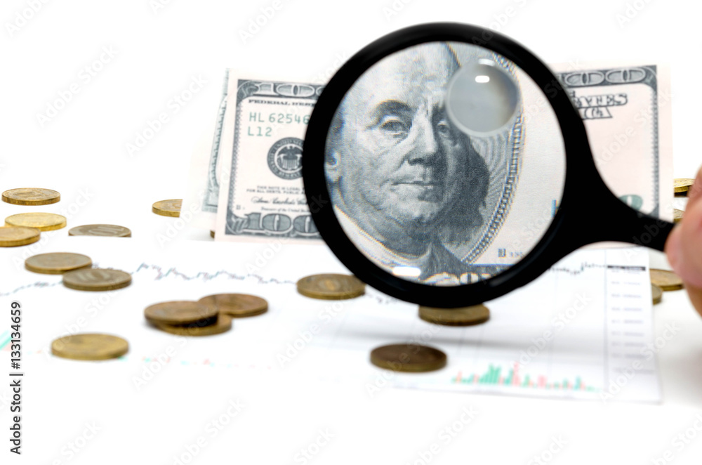 Viewing dollars with a magnifying glass Stock Photo | Adobe Stock