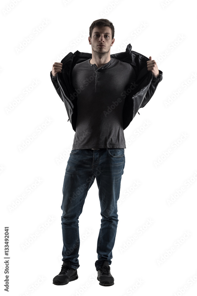 Back lit silhouette of young man taking off jacket. Full body length ...