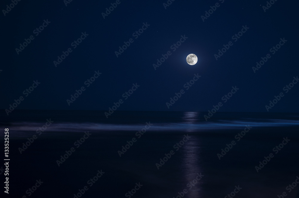 Full moon in night sky over moonlit water Stock Photo | Adobe Stock