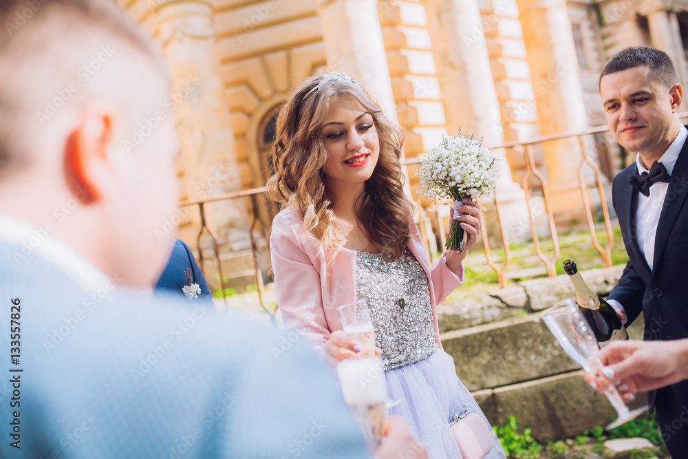 Bride and groom with happy groomsmen and bridesmaids having fun and ...