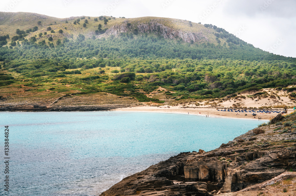 Cute bay of Majorca island. View of Cala Mesquida with sand beach and ...