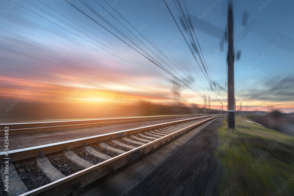Railroad in motion at sunset. Railway station with motion blur effect ...
