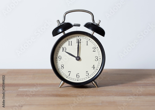 It is ten o'clock. The time is 10:00 am or pm. Retro clock isolated on ...