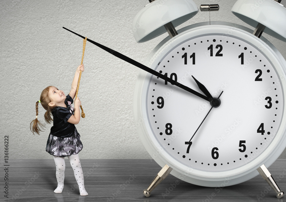 Little child pulling hand clock, time management concept Stock Photo ...