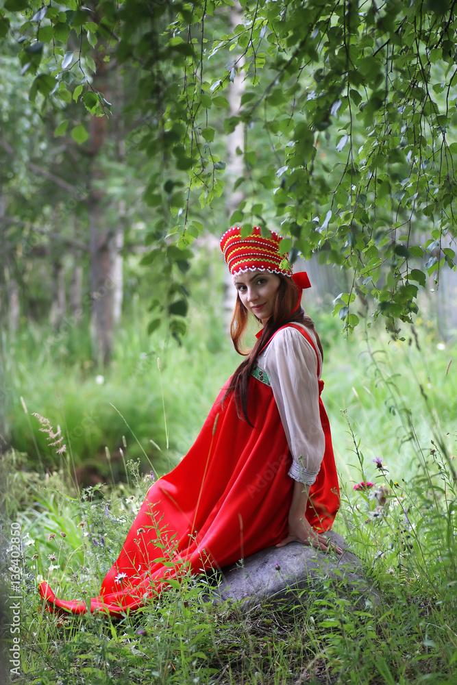 Slav in traditional dress is sitting in nature Stock Photo | Adobe Stock