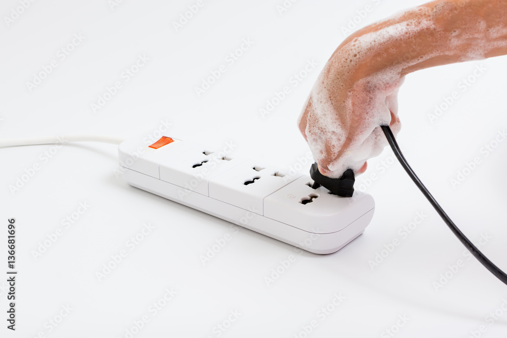 Wet hand of children are plugged. Concept of do not use electricity ...