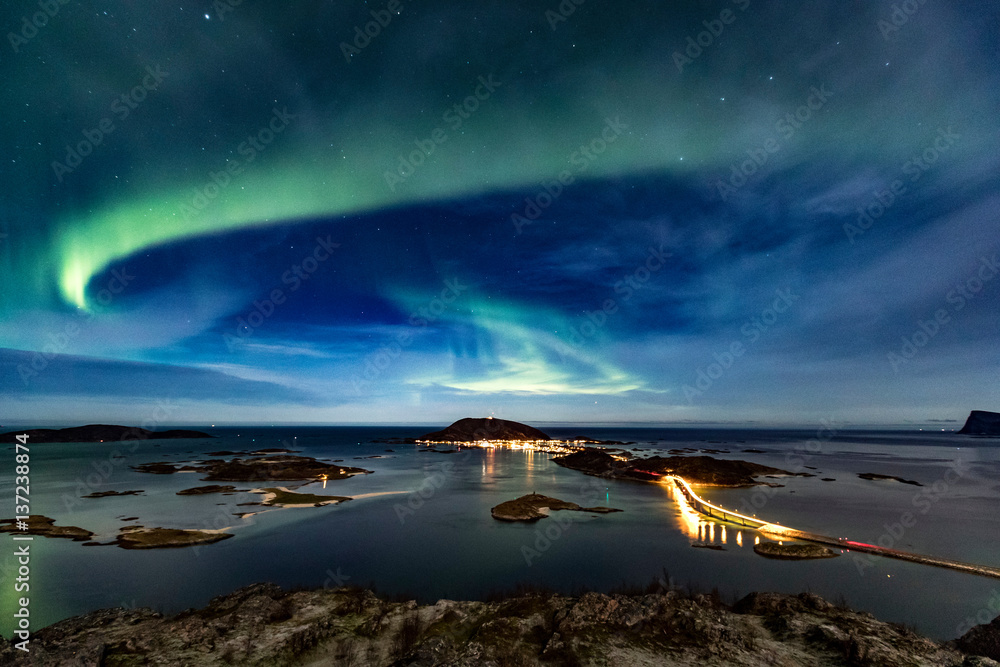 Northern lights (Aurora Borealis) in the night sky over famous Sommaroy ...