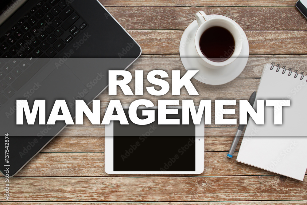 Tablet on desktop with risk management text. Stock Photo | Adobe Stock
