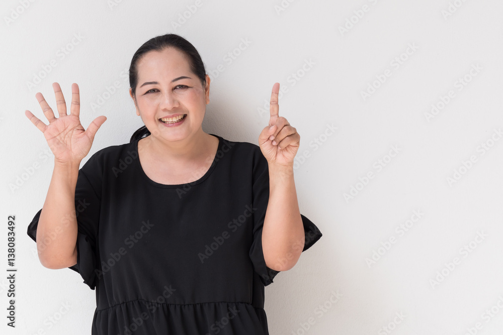happy, smiling woman pointing up six finger counting hand sign, middle ...