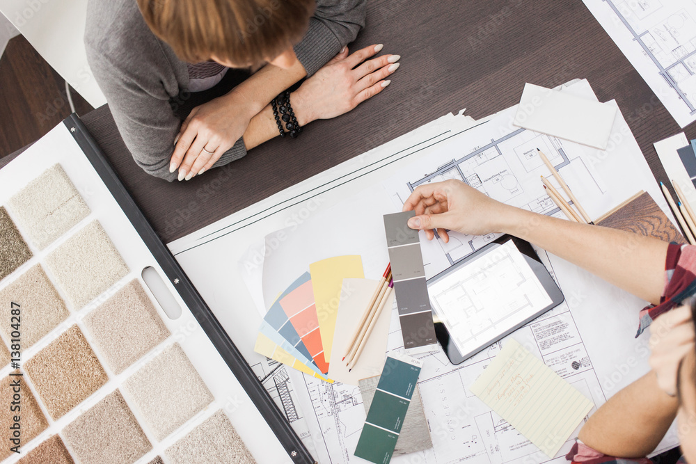 An interior designer reviews renovation plan with client Stock Photo ...