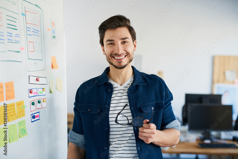 Happy web developer standing in office Stock Photo | Adobe Stock