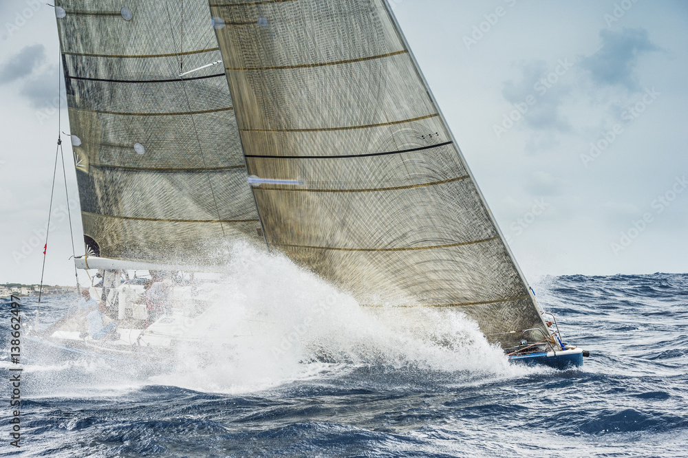 Sailing boat breaking waves Stock Photo | Adobe Stock