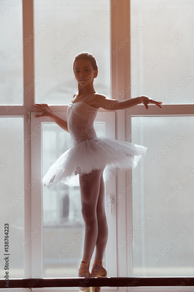 Young beautiful ballerina dancing on windowsill Stock Photo | Adobe Stock