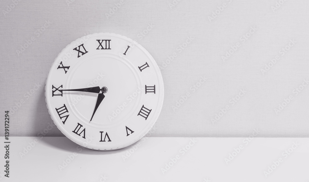 Closeup white clock for decorate show a quarter to seven or 6:45 a.m ...