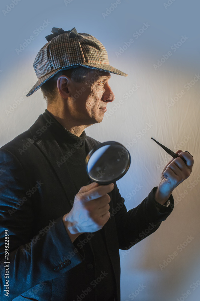 sherlock holmes in studio detective at work with magnifying glass and ...