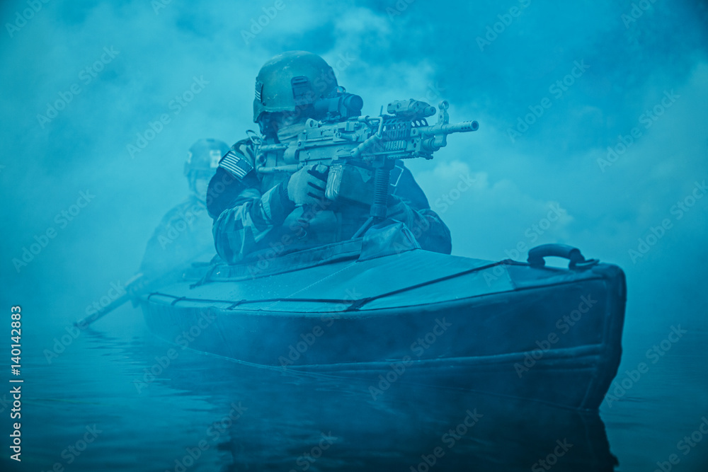 Special forces marine operators in camouflage uniforms paddling army ...