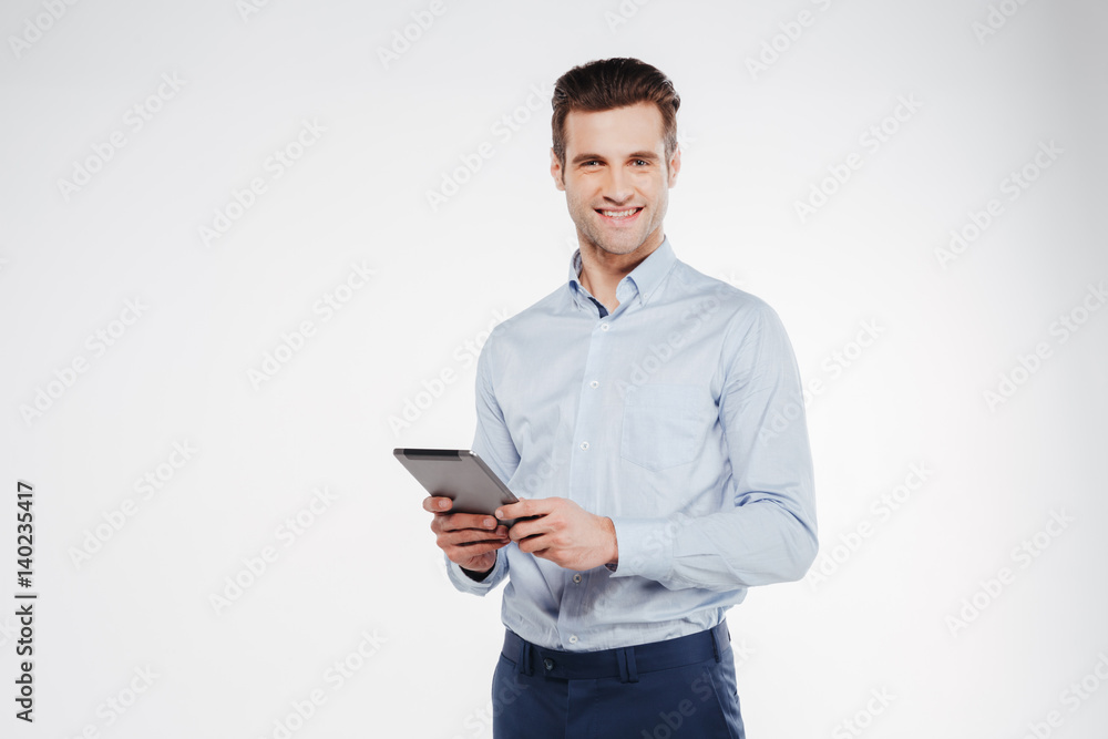 Smiling business man holding tablet computer Stock Photo | Adobe Stock