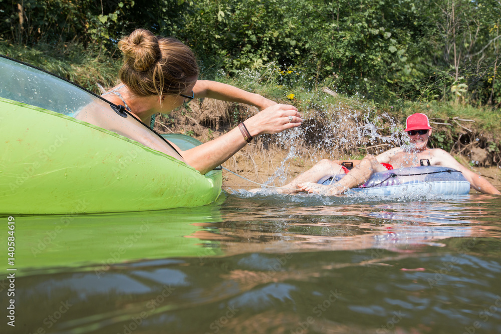 Couple tubing down the river in the summer Stock Photo | Adobe Stock